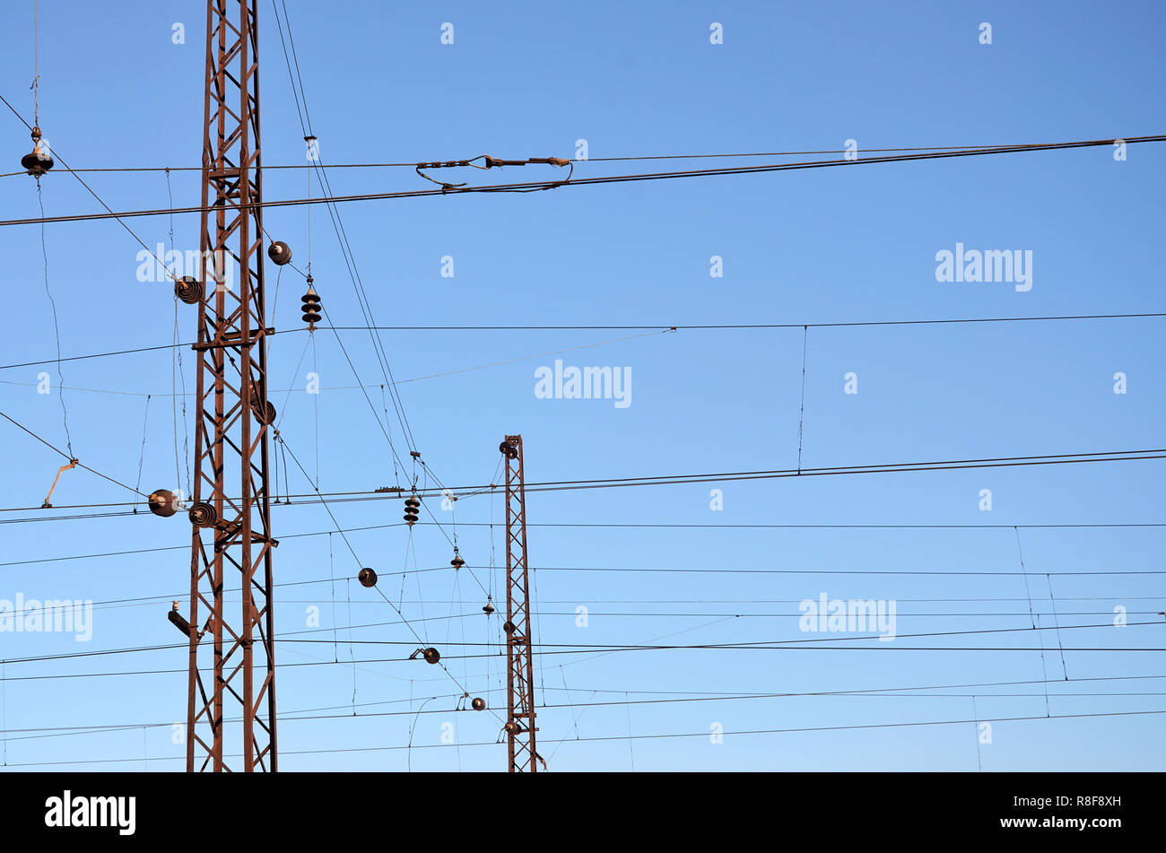 Railroad overhead lines against clear blue sky, Contact wire. High ...