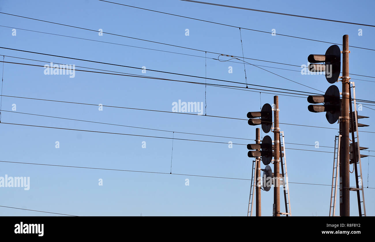 Railroad traffic light against clear blue sky, Contact wire. High ...