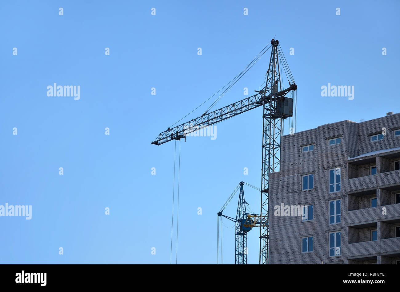 Working tall cranes inside place for with tall buildings under ...