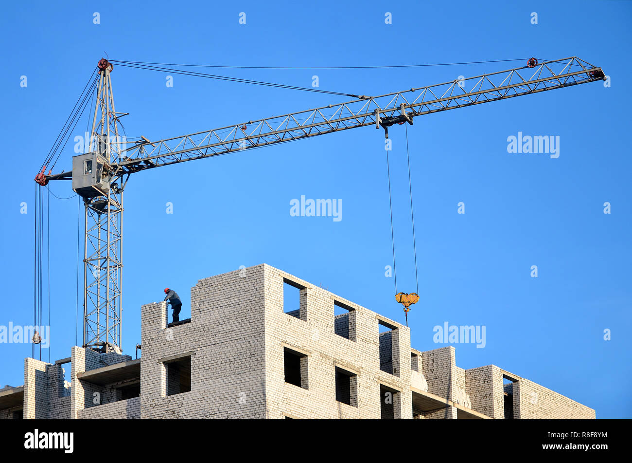 Working tall cranes inside place for with tall buildings under ...