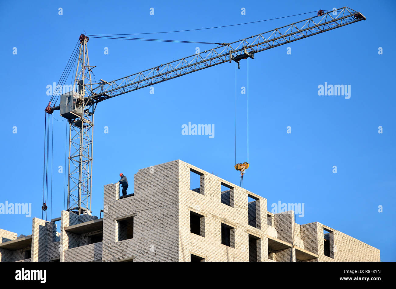 Working tall cranes inside place for with tall buildings under ...