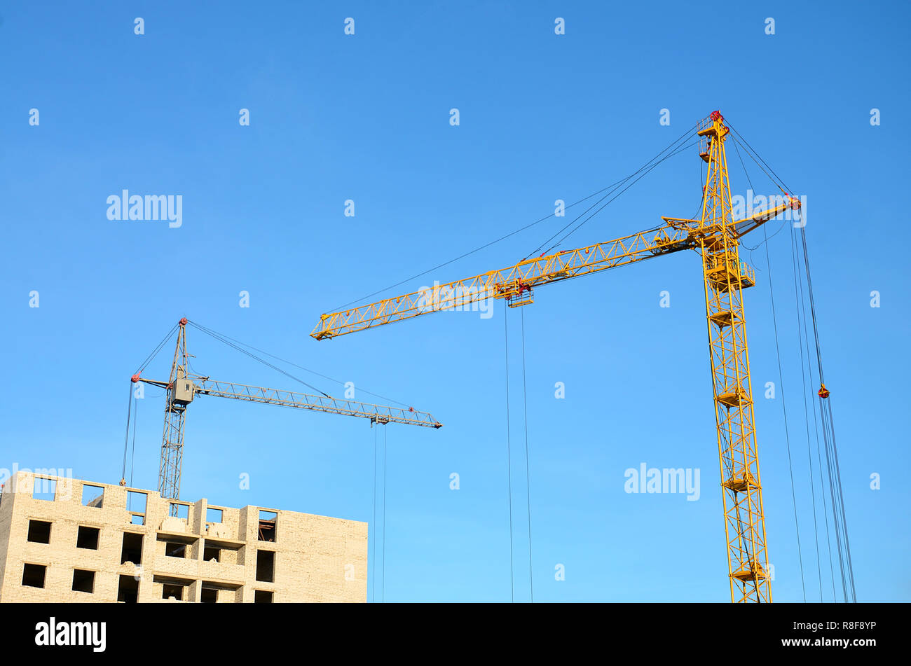 Working tall cranes inside place for with tall buildings under ...