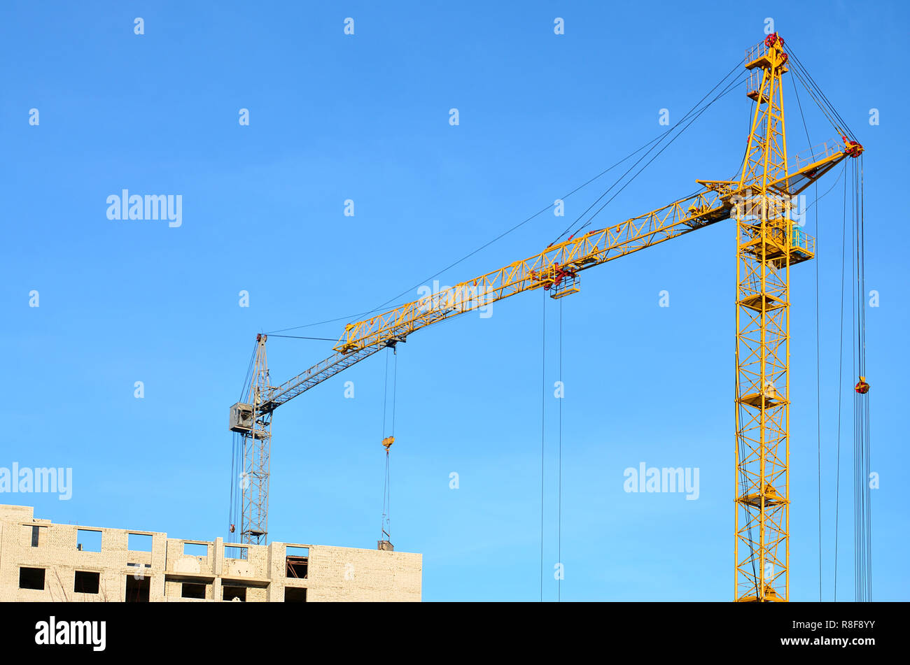 Working tall cranes inside place for with tall buildings under ...