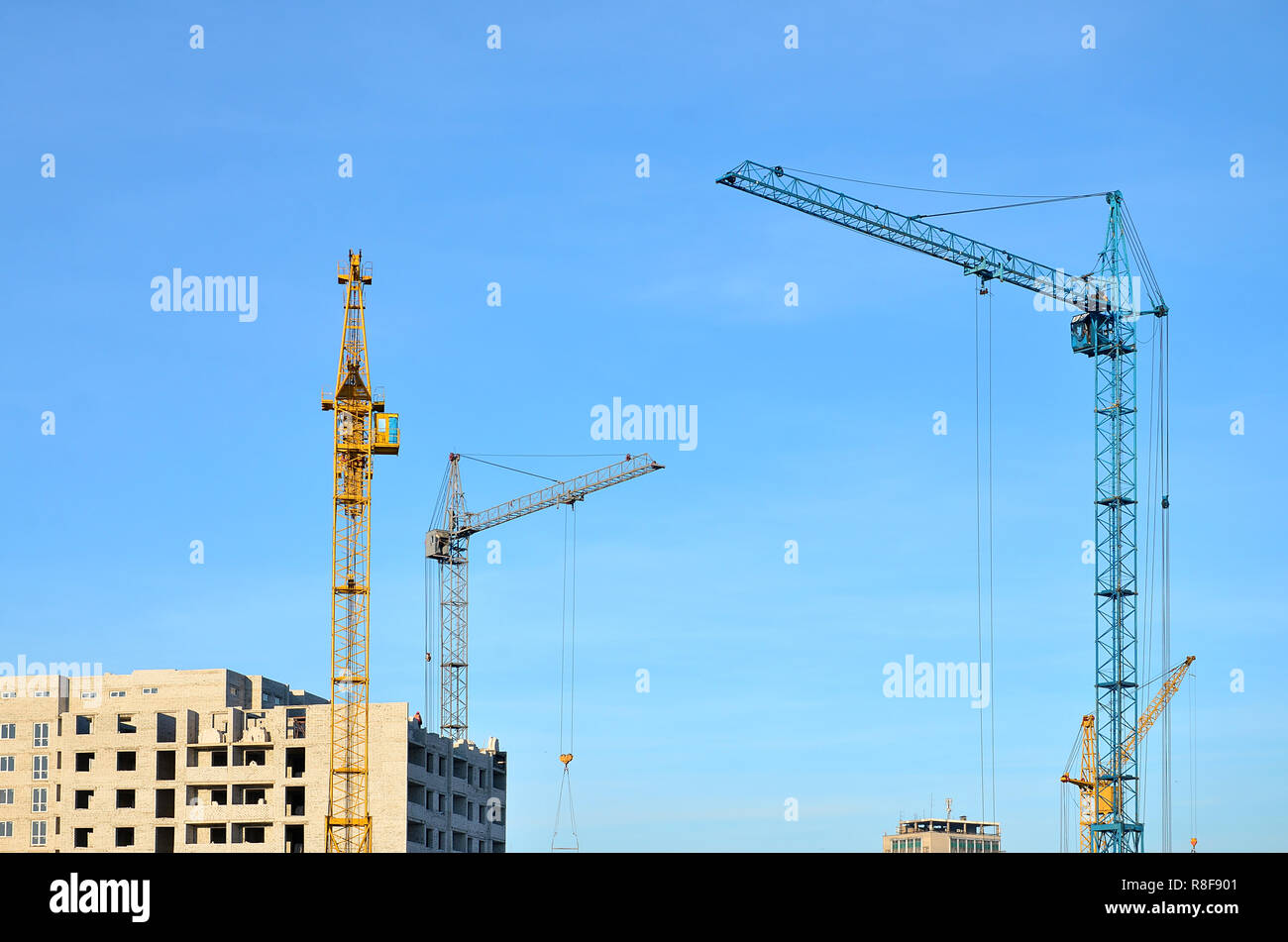 Working tall cranes inside place for with tall buildings under ...