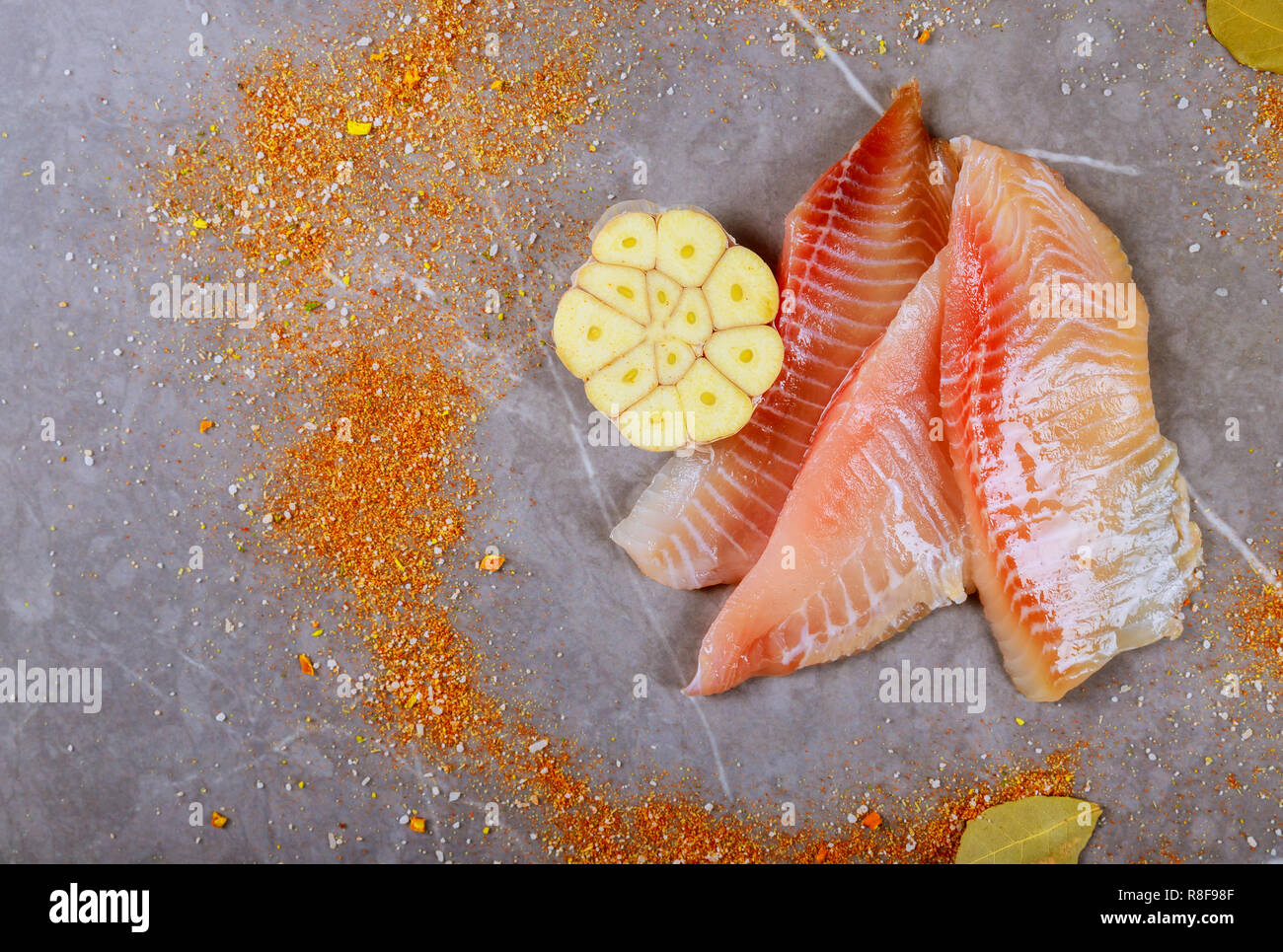 Raw preparation fish fillets tilapia on cutting granite cooker of board ...