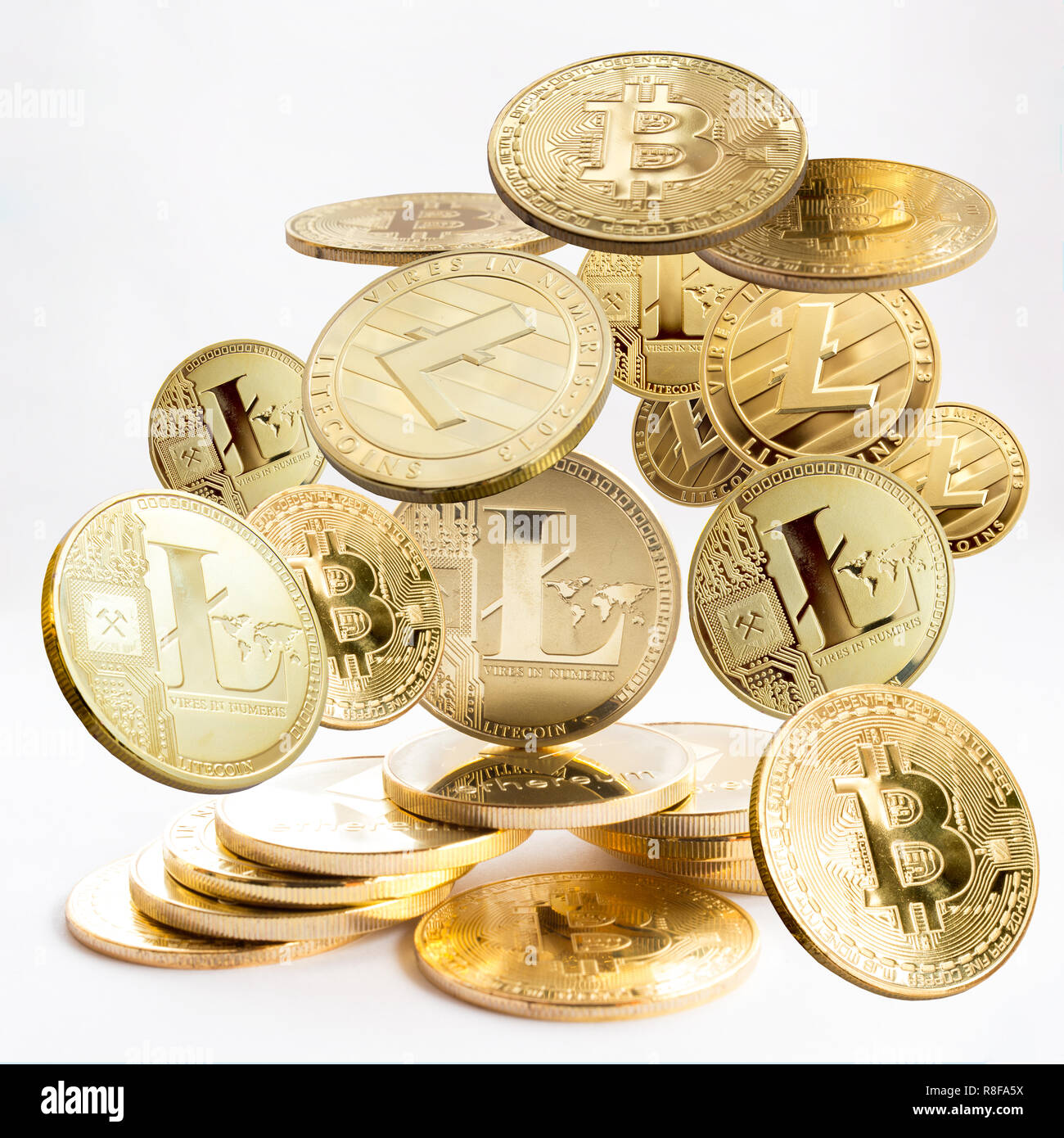 On a white background are gold coins of a digital crypto currency ...