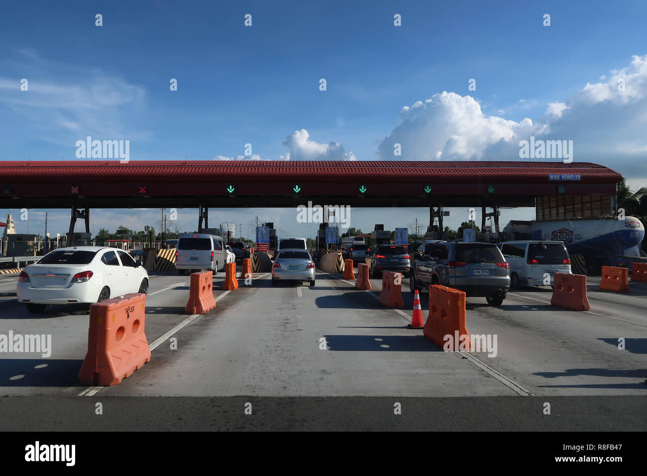 Cars pass through a tollbooth station in the North Luzon Expressway ...