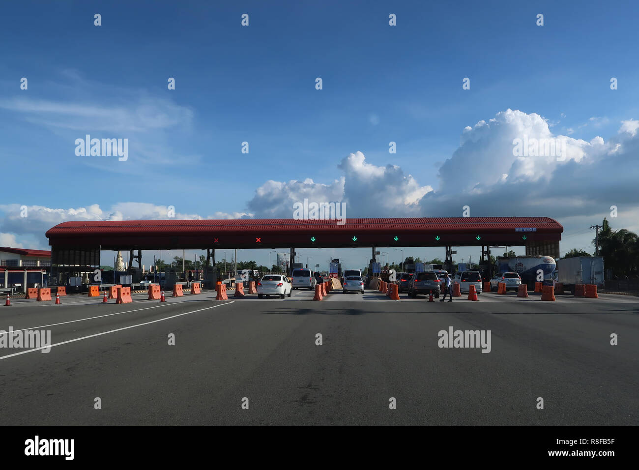 Cars pass through a tollbooth station in the North Luzon Expressway ...