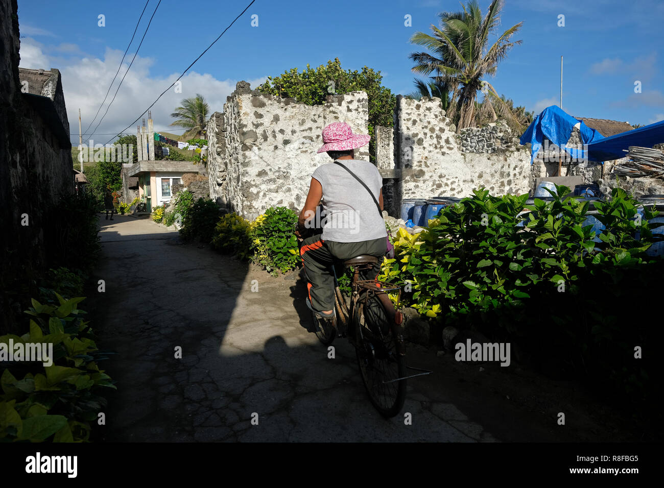 A villager rides a bicycle in Savidug Barrio located in Sabtang the ...