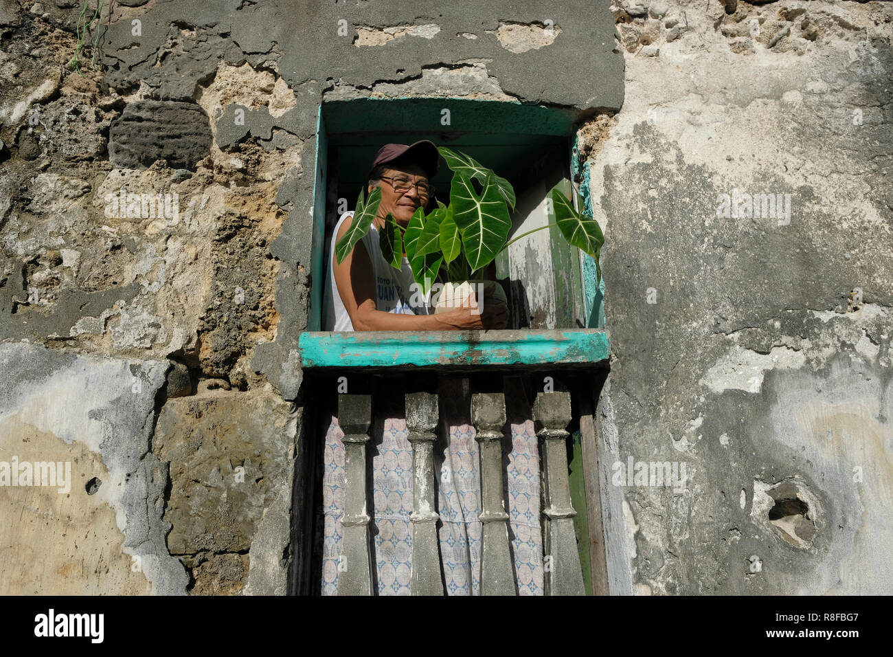 An Ivatan woman peeps out from a window in Savidug Barrio located in ...