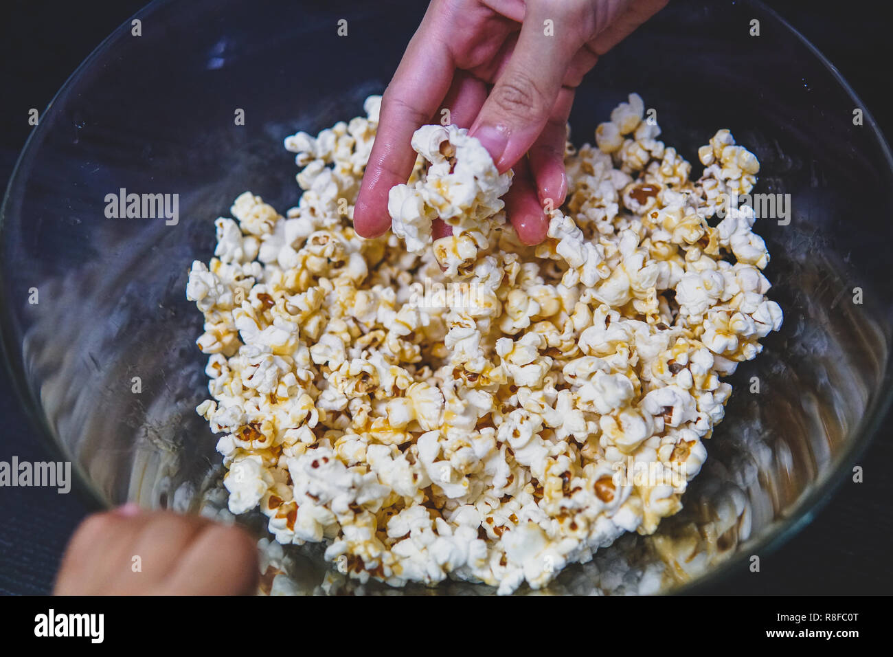 Grabbing popcorn hi-res stock photography and images - Alamy