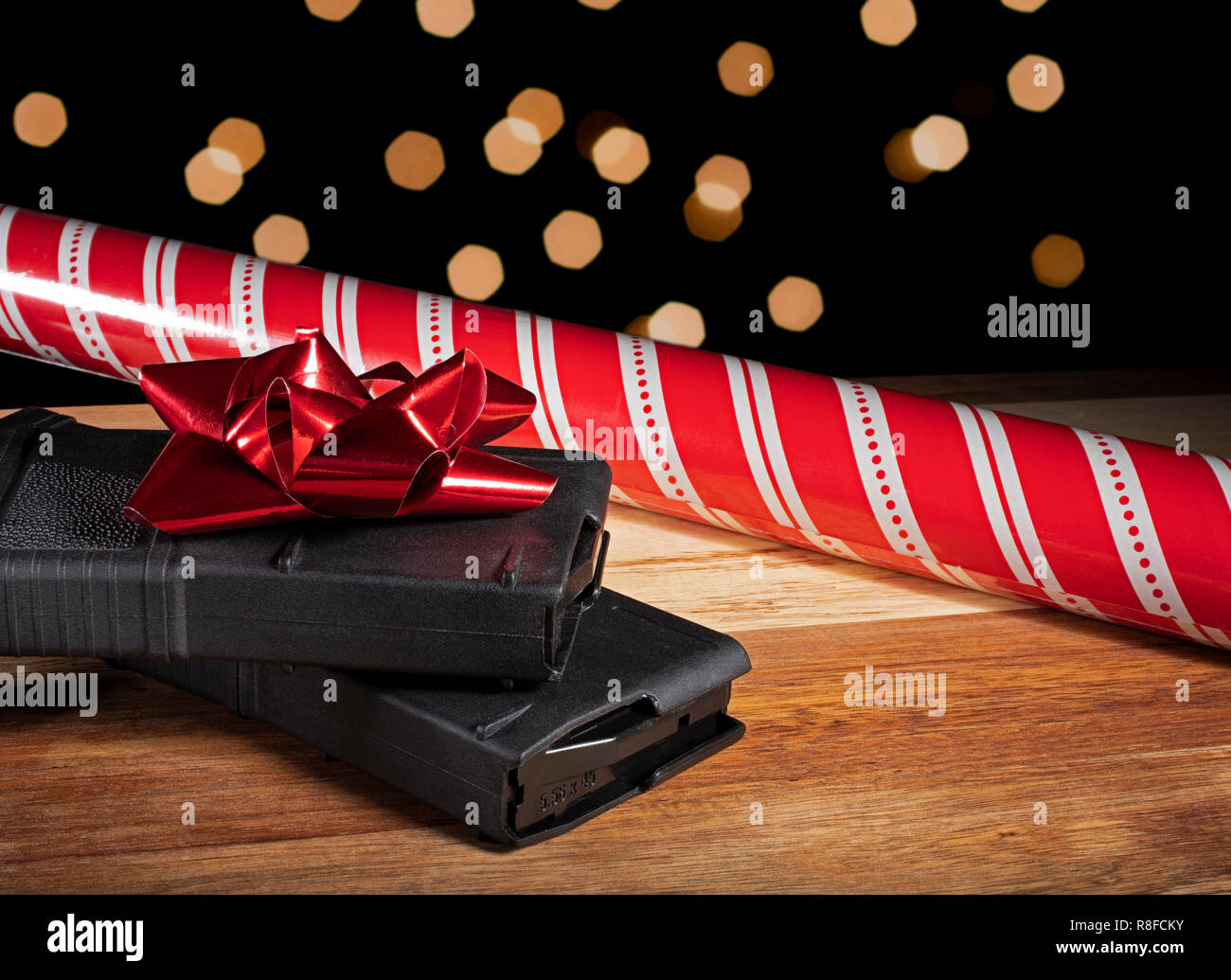 Polymer rifle magazines with Christmas wrapping paper and lights behind ...