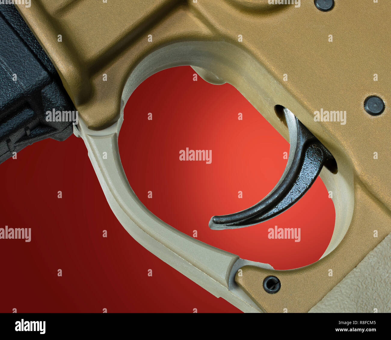 Assault rifle trigger with a red background behind Stock Photo - Alamy