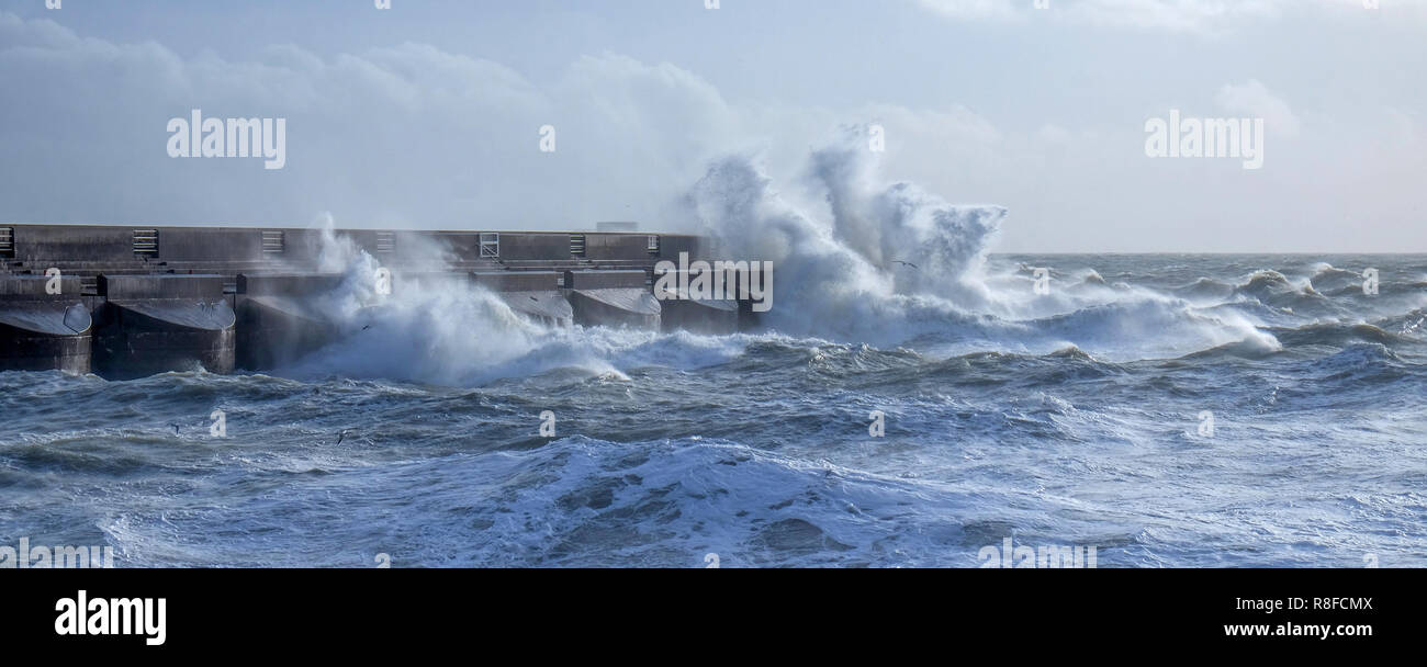 Dramatic stormy sea breaking against Brighton marina black stone ...