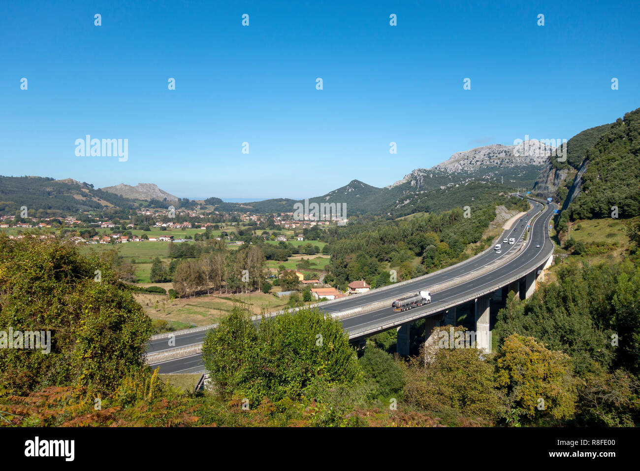 Highway in the middle of the green mountains and concrete viaduct, in ...