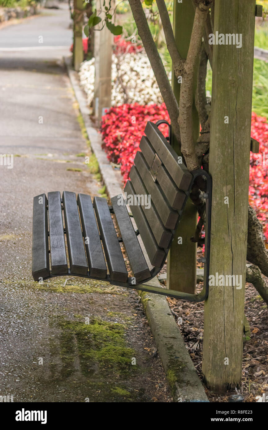 bench sitting in shaded area in flower garden in washington Stock Photo ...