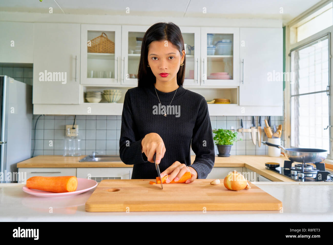 Beautiful woman posing - standing, slicing and looking at camera Stock ...