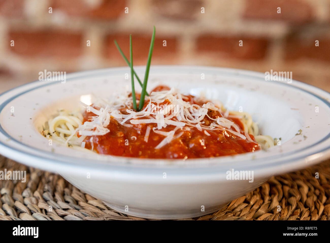 side view of spaghetti bolognese with tomato sauce, meat and cheese in ...