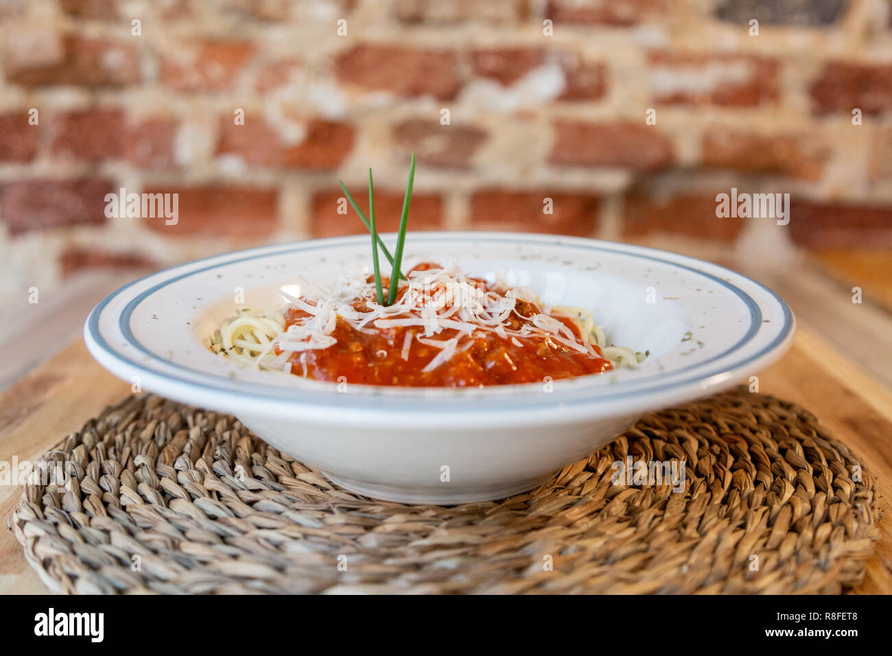 side view of spaghetti bolognese with tomato sauce, meat and cheese in ...