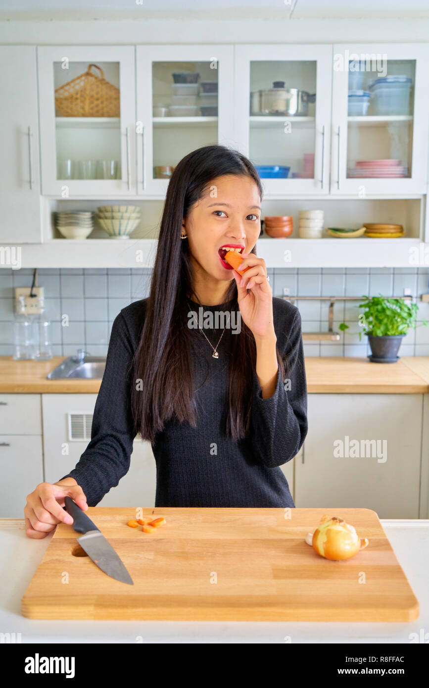 Beautiful woman posing - standing, eating and looking at camera Stock ...