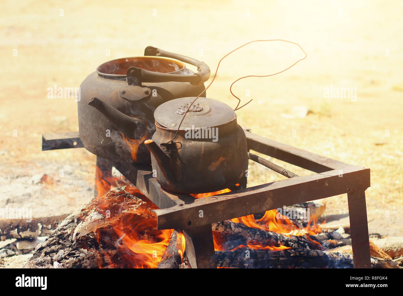 Cooking food in a rustic old kettle on bonfire in the forest Stock ...
