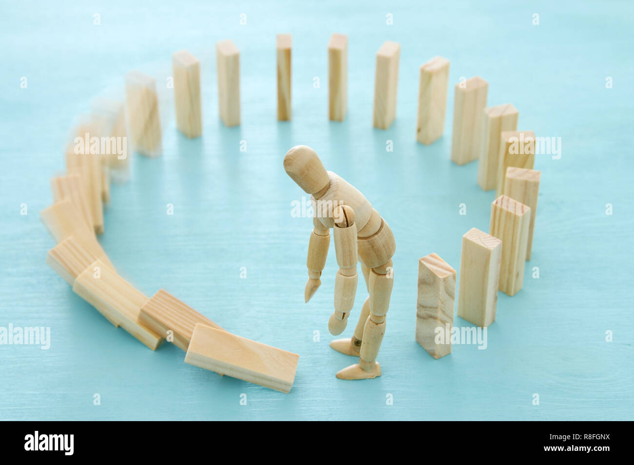 Thoughtful confused wooden dummy building circle domino puzzle and ...