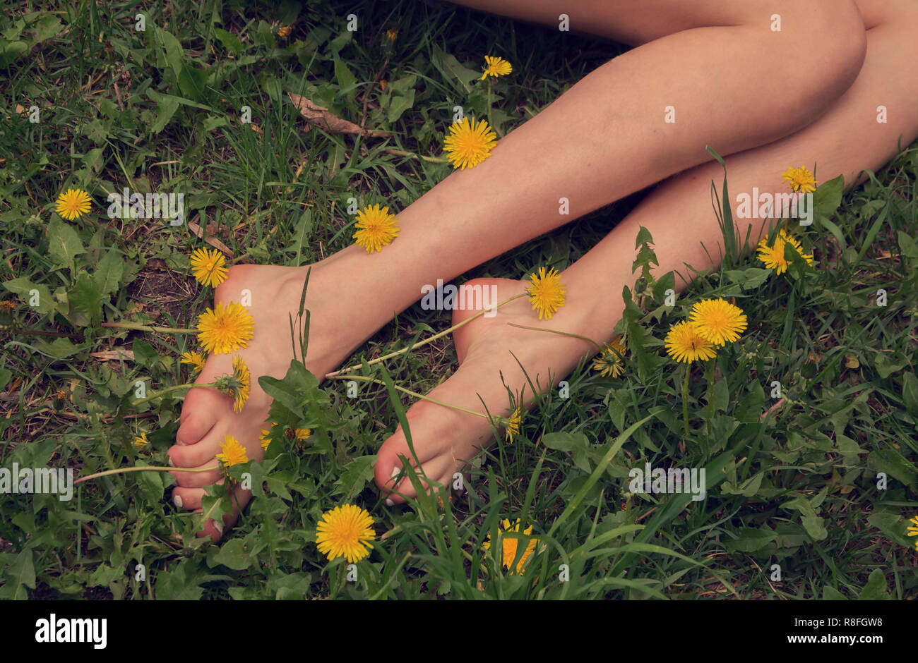 Painted white lacquer nails on the feet of the girl Stock Photo - Alamy