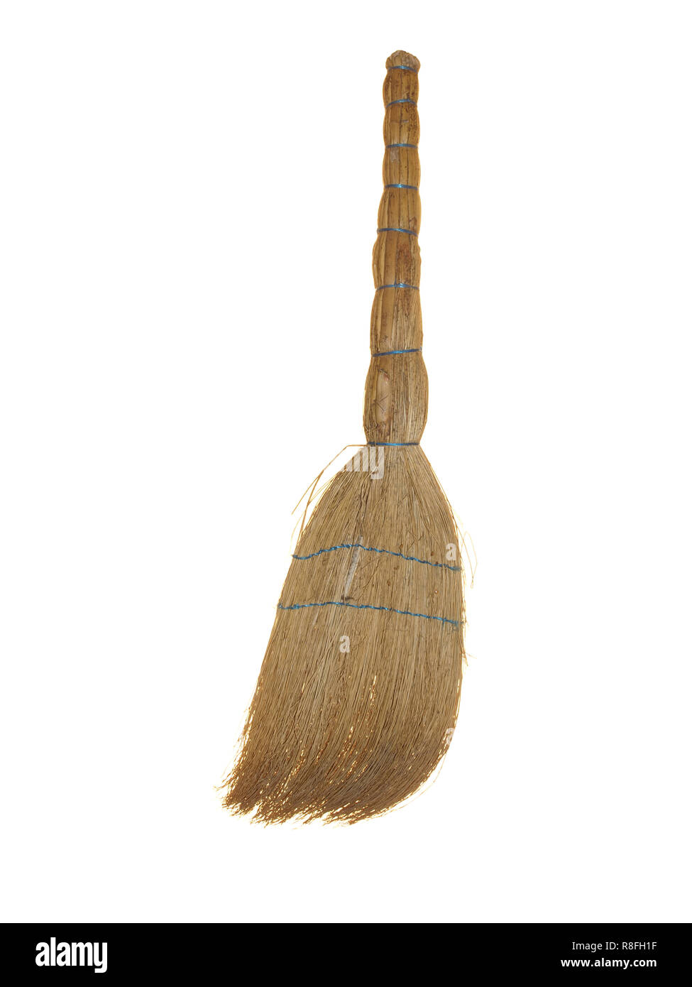 Old broom of sorghum tied with a blue rope isolated on white background ...