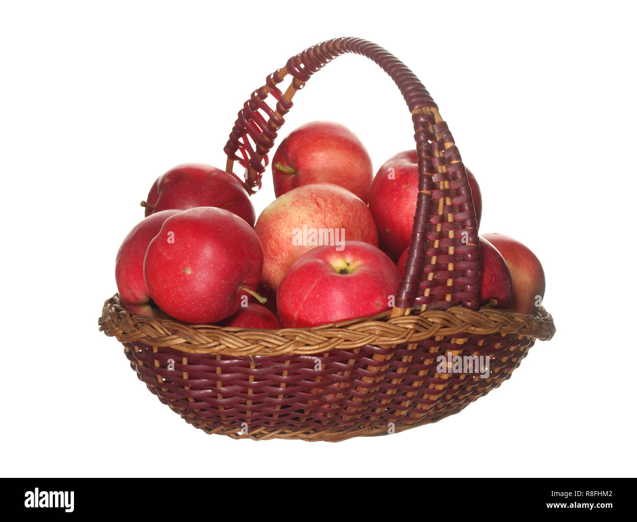 Red apples in a decorative fruit basket isolated on white background ...