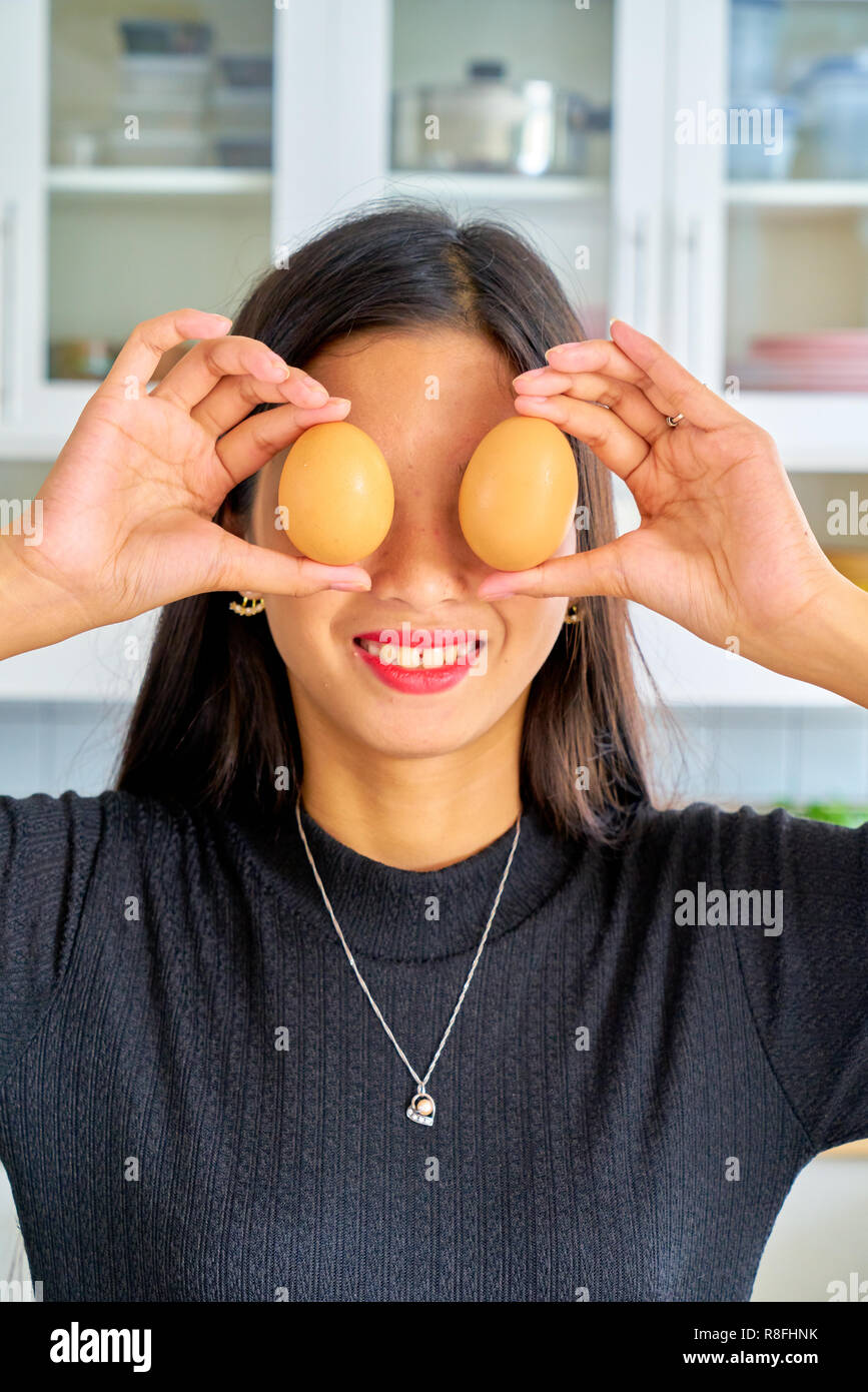 Beautiful woman posing - egg on the eye, smiling Stock Photo - Alamy