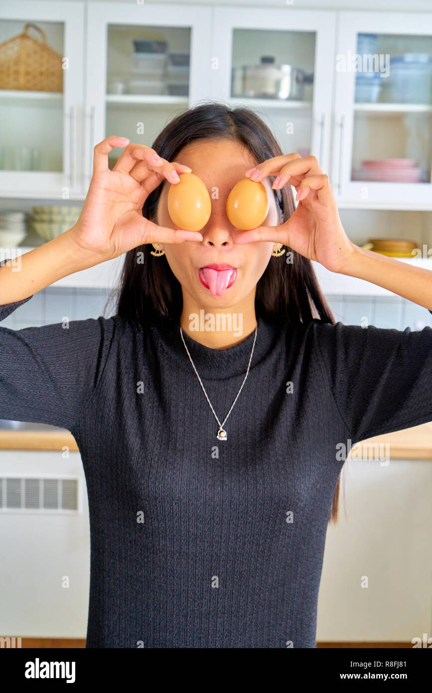Beautiful woman posing - egg on the eye Stock Photo - Alamy