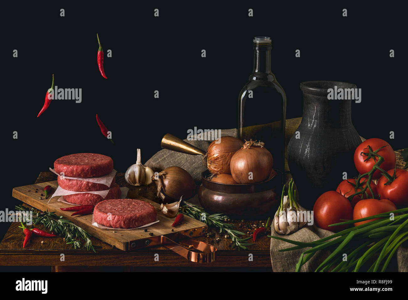 Raw beef burger, traditional barbecue, still life with vegetables and ...