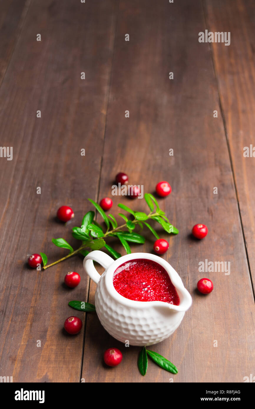Cranberry sauce on brown wooden background with copy space, vertical ...