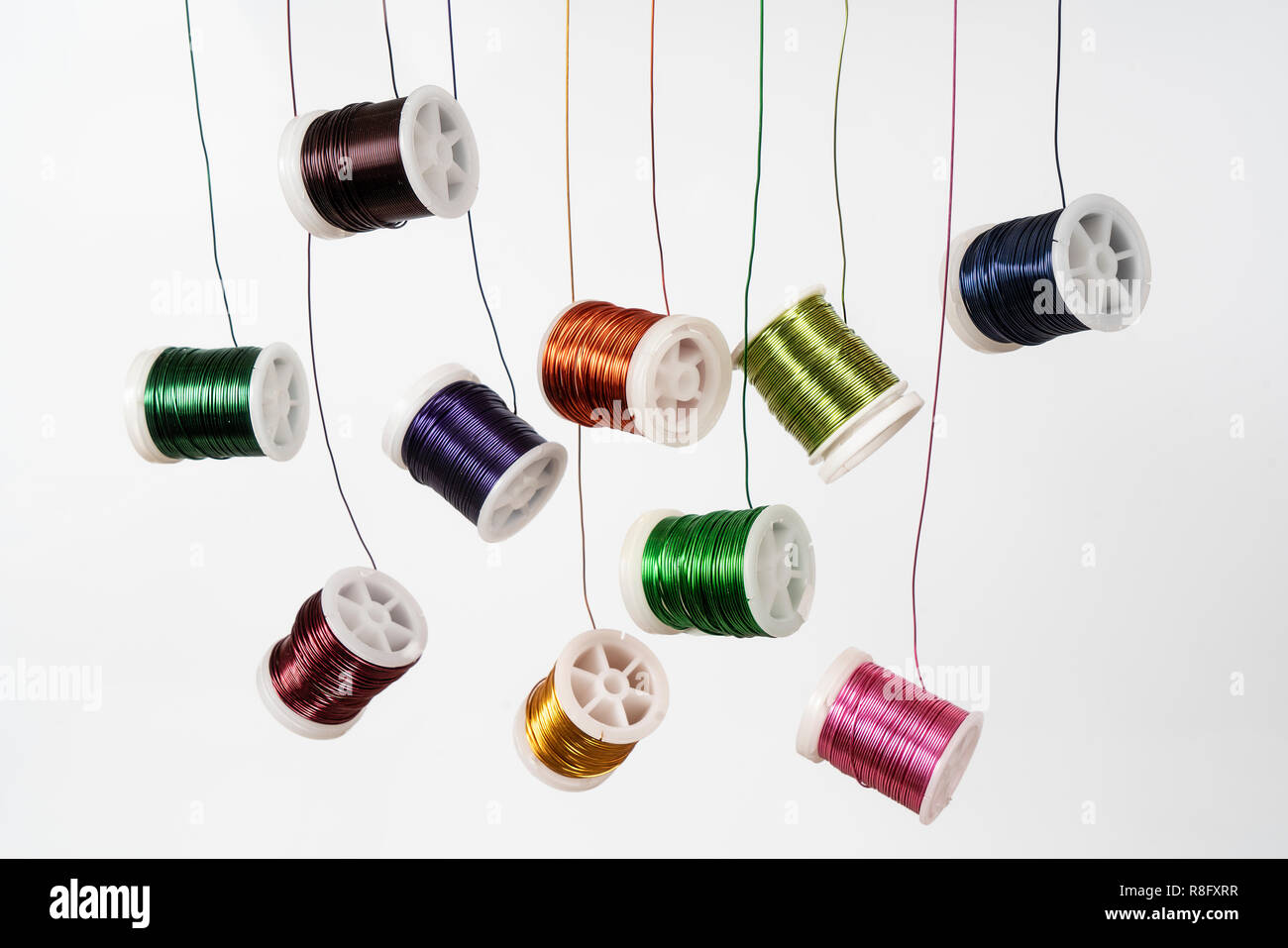Some spools of colored metallic thread Stock Photo - Alamy