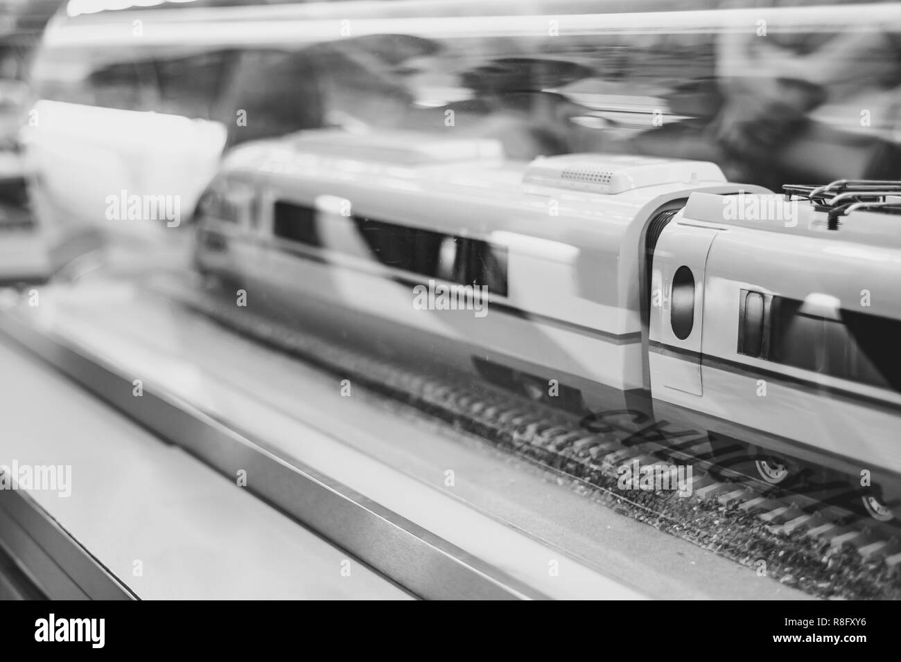 Miniature toy model of modern train crossing bridge Stock Photo - Alamy