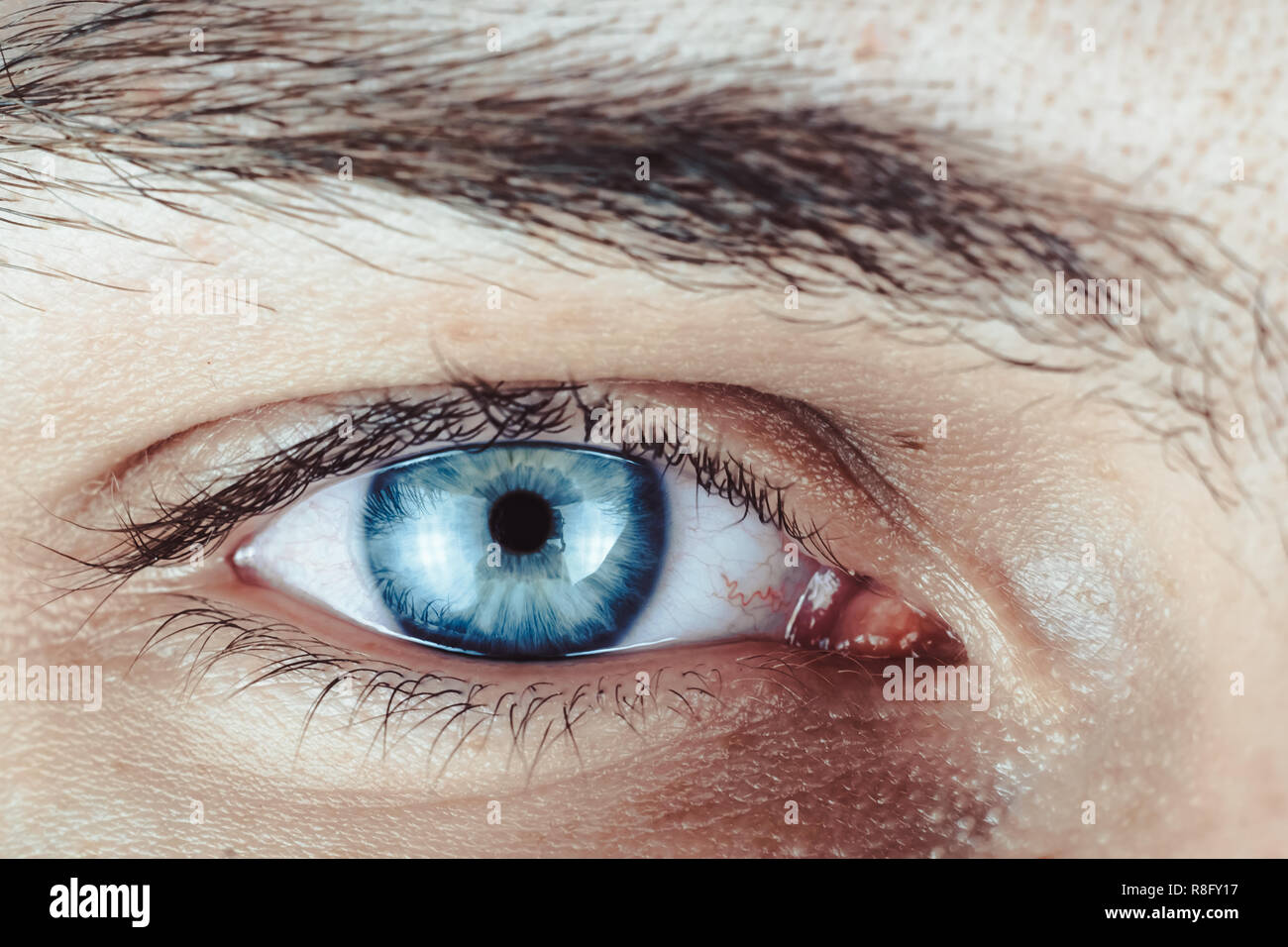 Macro image of human blue eye with unusual light Stock Photo - Alamy
