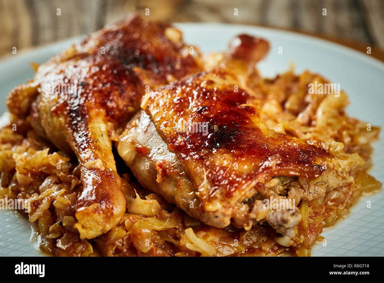 Roasted oven baked duck legs on fresh cabbage caramelized Stock Photo ...