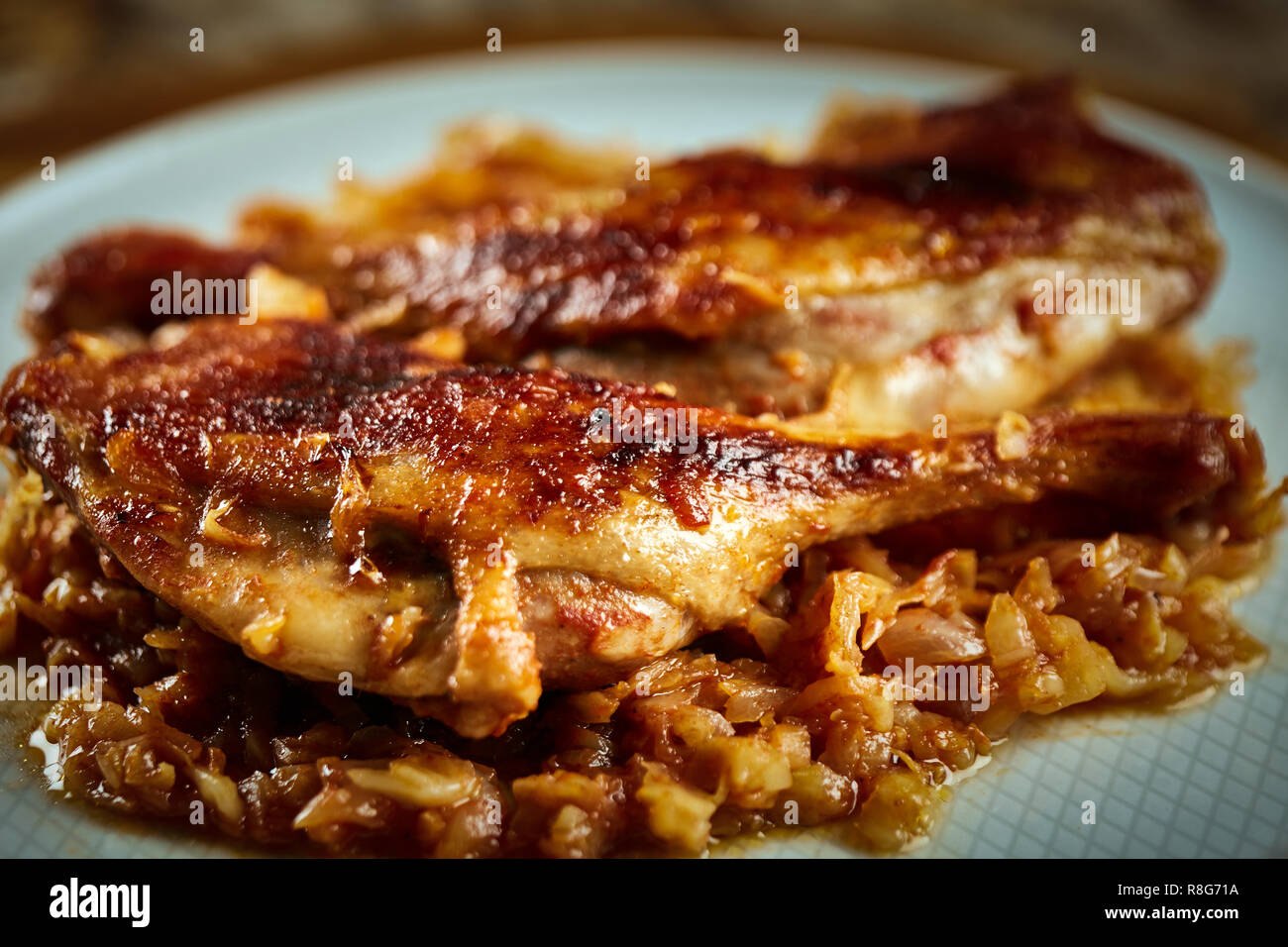 Roasted oven baked duck legs on fresh cabbage caramelized Stock Photo ...