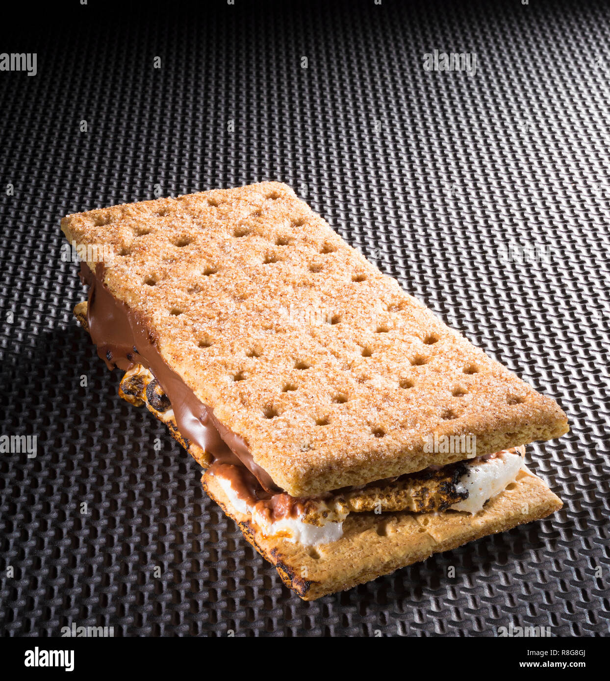 Backlit camping smore on a rubber and textured background Stock Photo ...