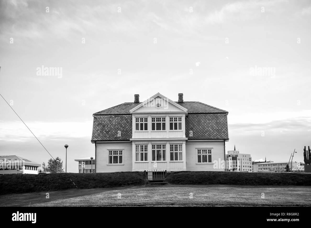 House with green lawn on blue sky in reykjavik, iceland. Architecture ...