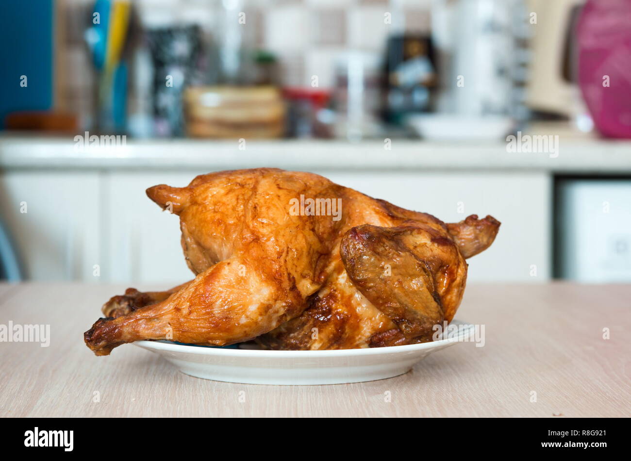 Roasted chicken on the plate in kitchen Stock Photo - Alamy