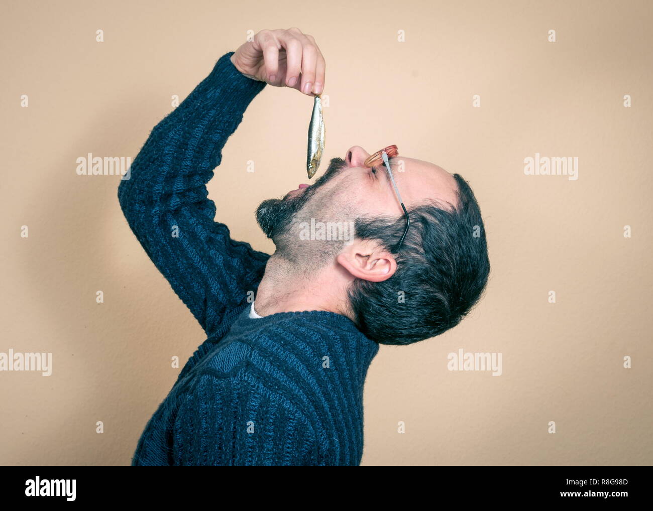 Young man eating fresh fish hi-res stock photography and images - Alamy