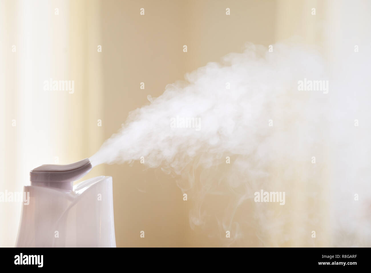 Humidifier spreading steam into the living room Stock Photo - Alamy