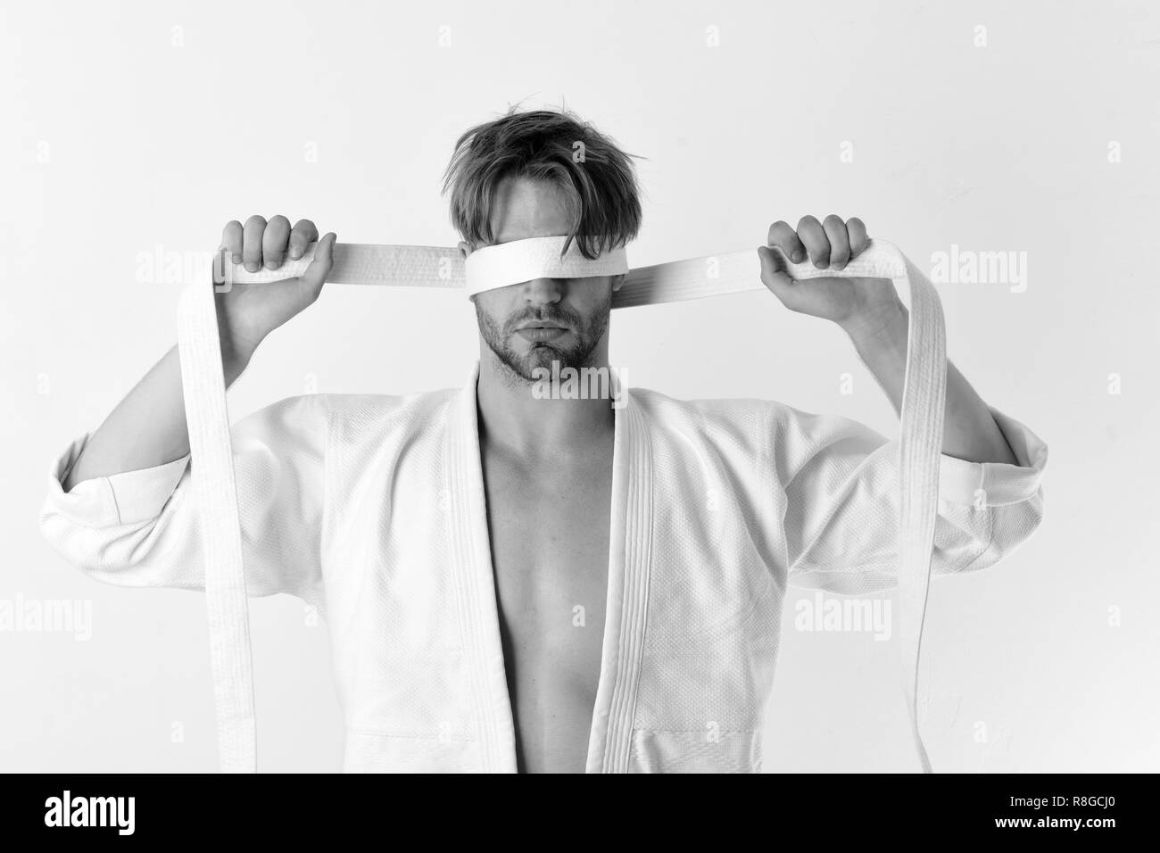 Karate fighter with strong body holds white belt. Japanese karate ...