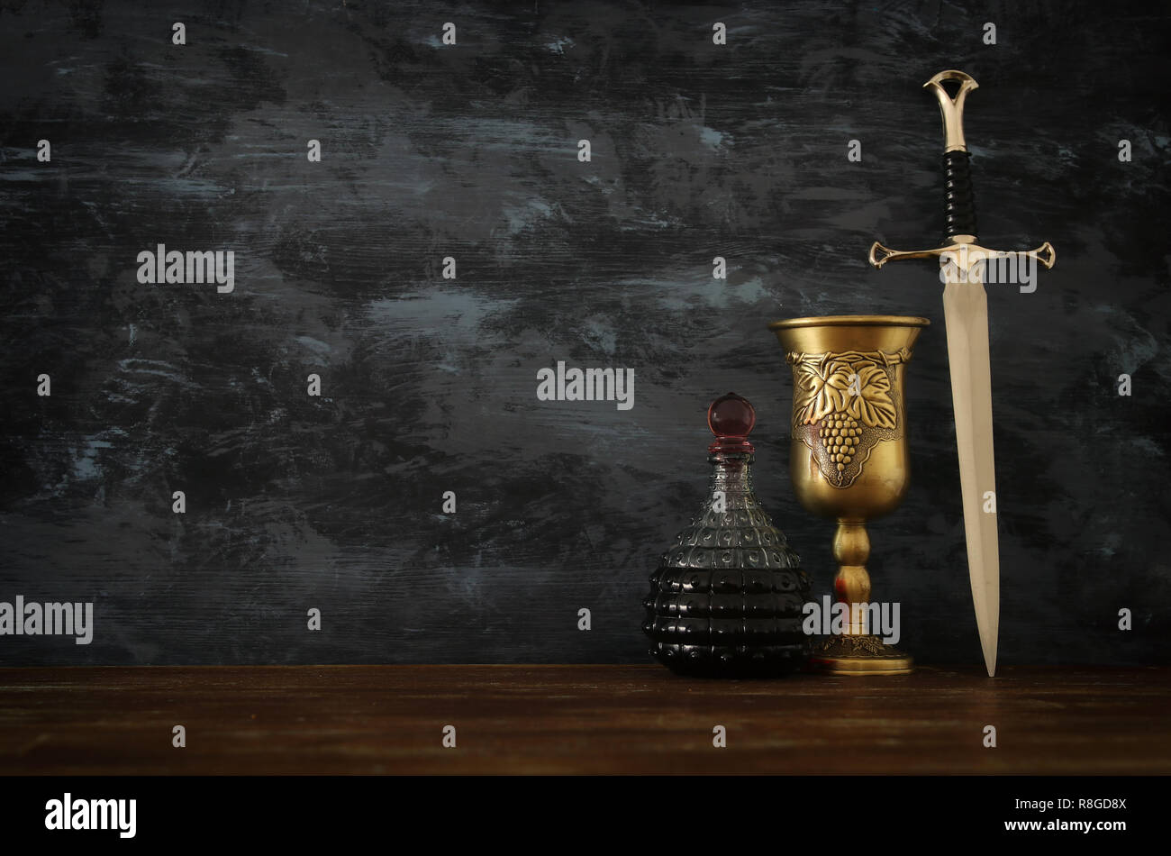 low key image of wine cup and sword. fantasy medieval period Stock ...