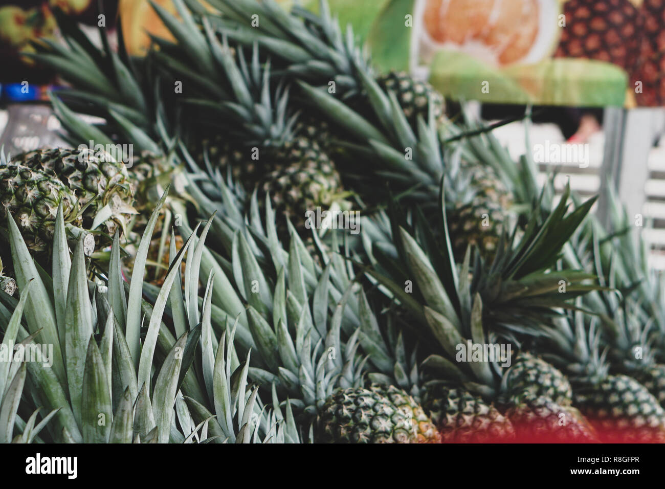 Pineapple on display at market for sale Stock Photo - Alamy