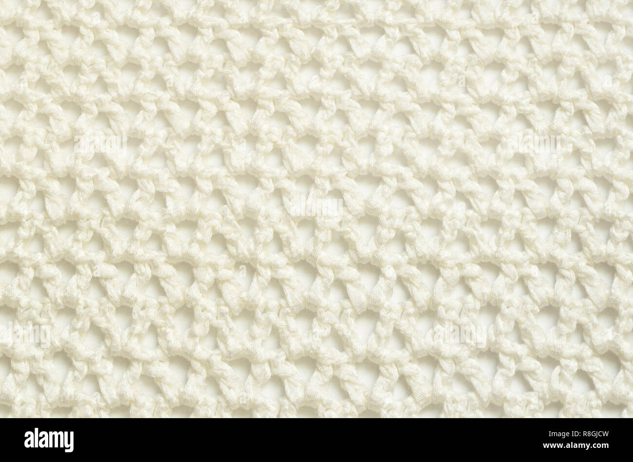 White crochet fabric with a repeating pattern Stock Photo - Alamy