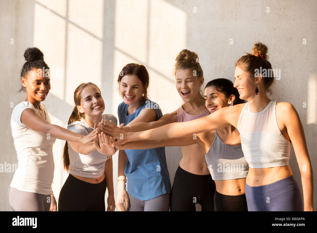 Sporty girl team starting workout putting their hands together Stock ...