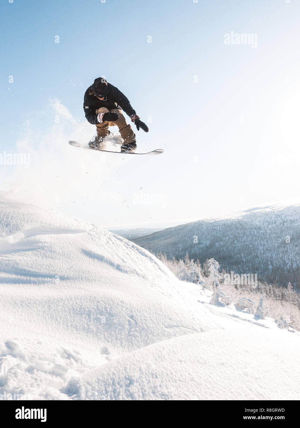 Snowboarder Jumping Across The View of The Highlands Stock Photo - Alamy