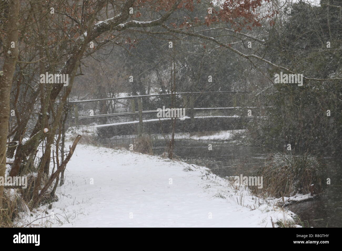 Bridge over river snow Stock Photo - Alamy